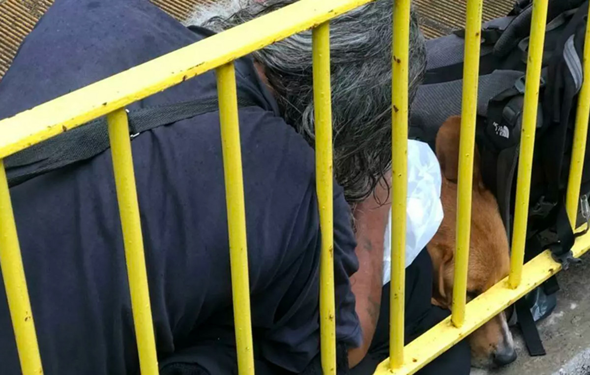 Έβρεχε και άστεγος έβγαλε το μπουφάν για να σκεπάσει το σκυλί του ...